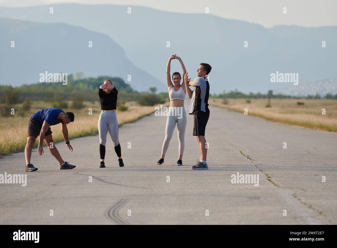 Diverse Group of Athletes Prepare Together for a Run Stock Photo - Alamy