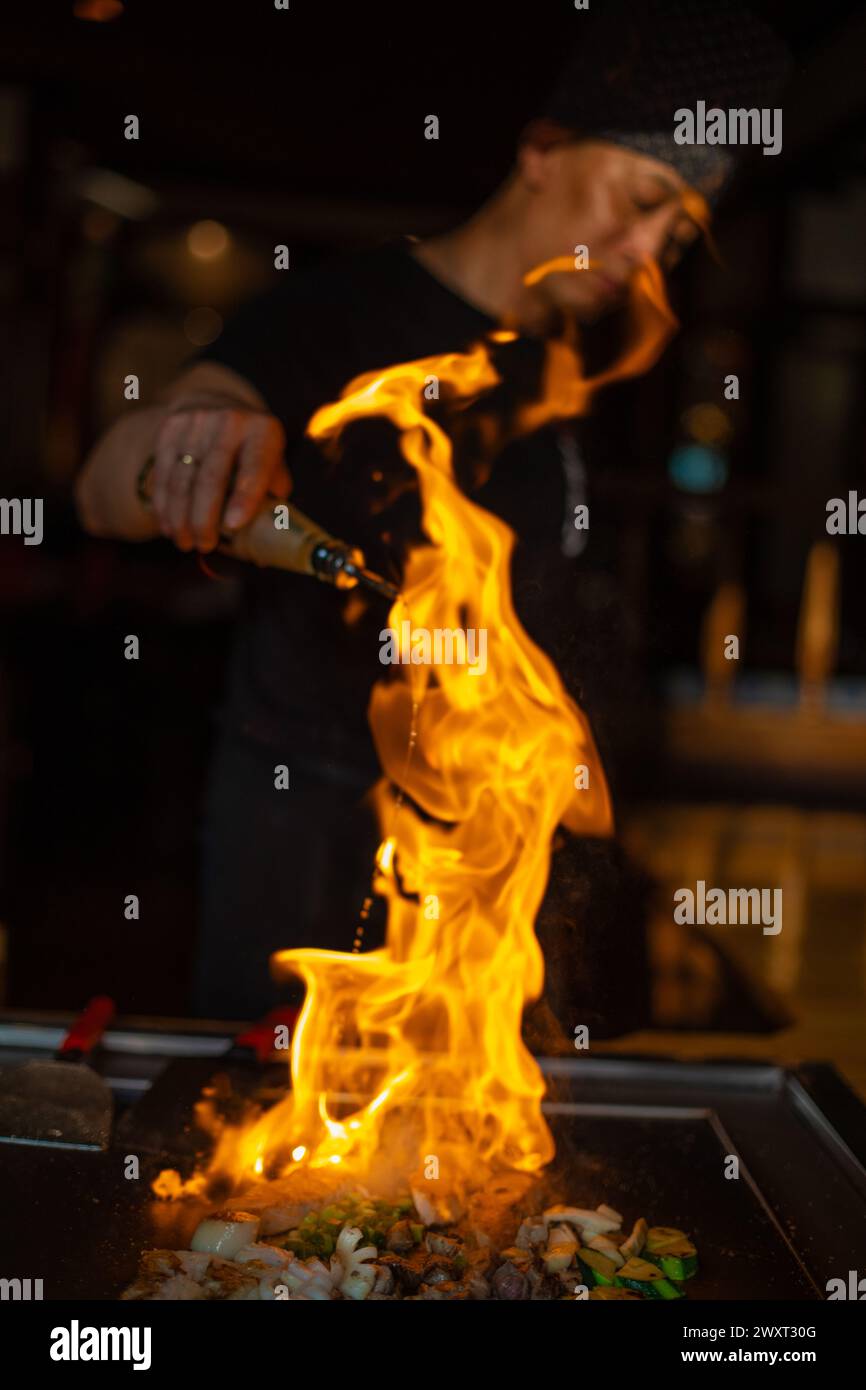 Berlin, Germany 08. 16. 2023. Teppanyaki chef cooking at teppan in a ...