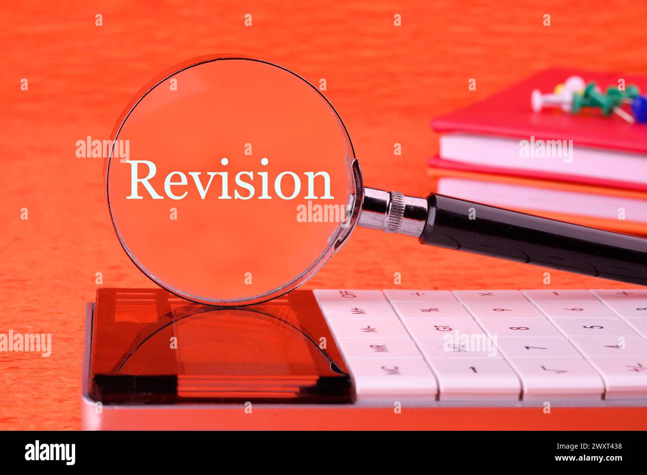 Revision word through a magnifying glass in white font on an orange ...