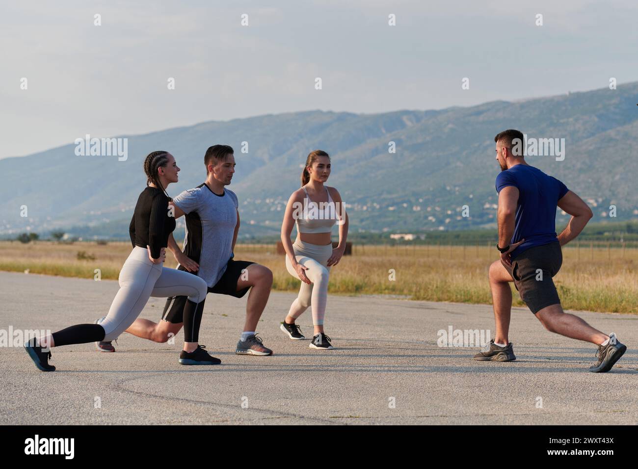 Diverse Group of Athletes Prepare Together for a Run Stock Photo - Alamy