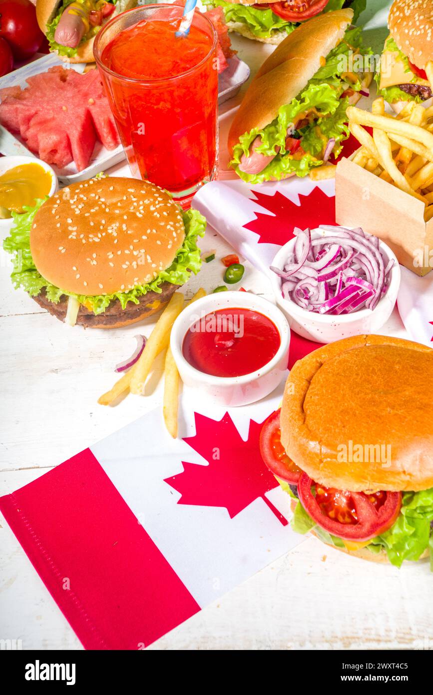 Set of various Canada Day bbq food. Picnic party table with maple leaf shaped watermelon, flags ...