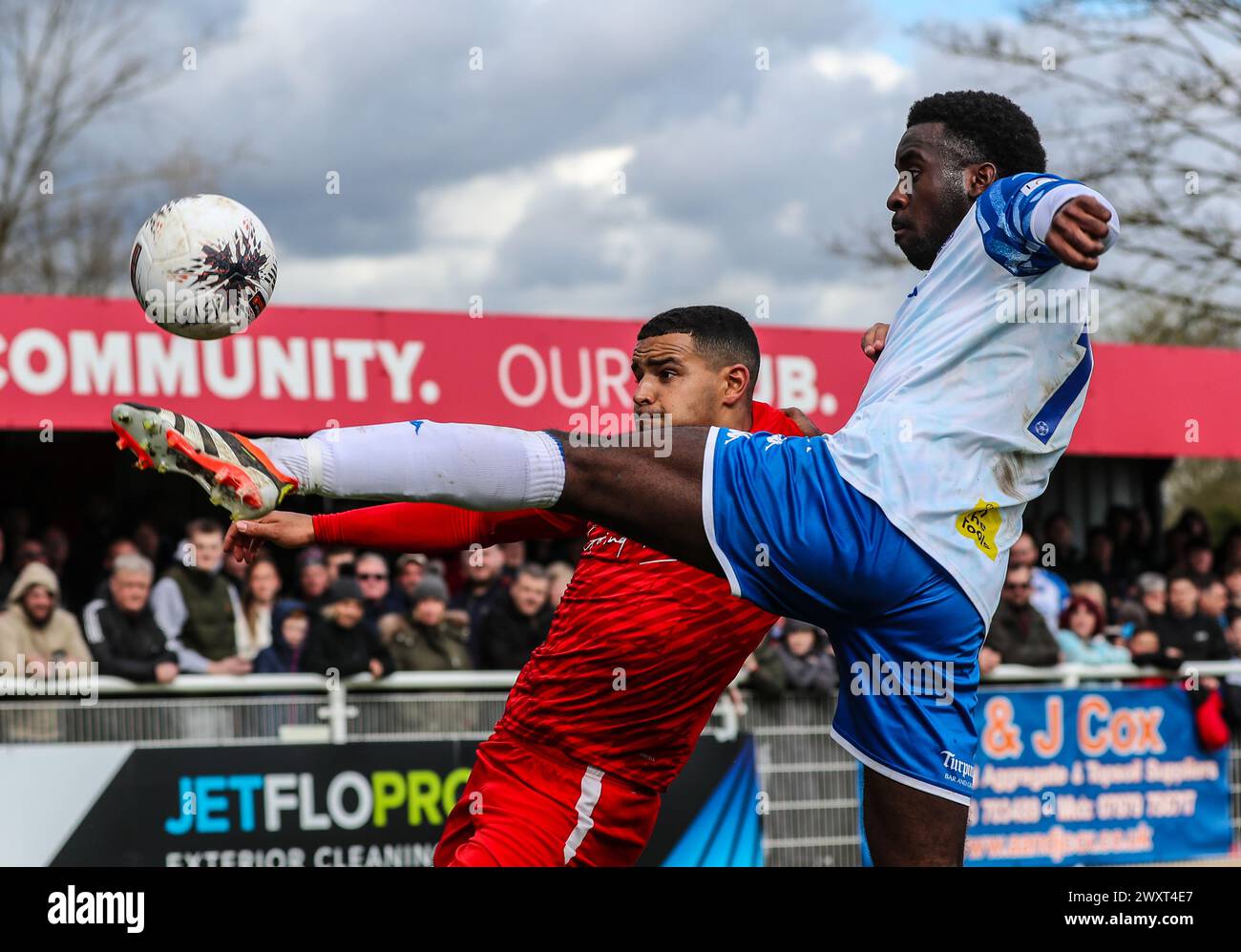Tamworth’s Ben Acquaye stretches to beat Brackley Town’s Tyler Little to the ball Stock Photo ...