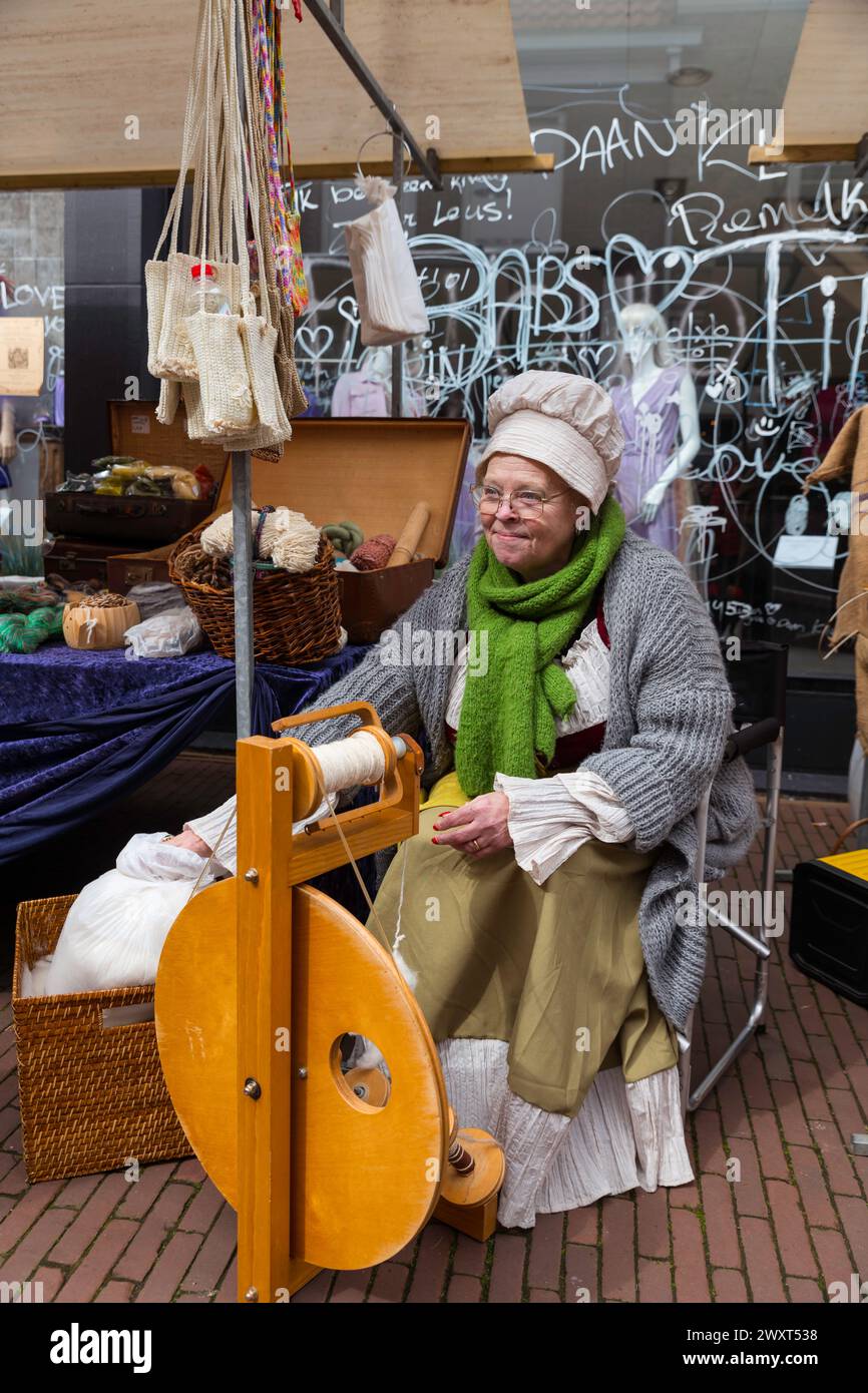 woman spinning on a spining wheel in traditional costume Stock Photo ...