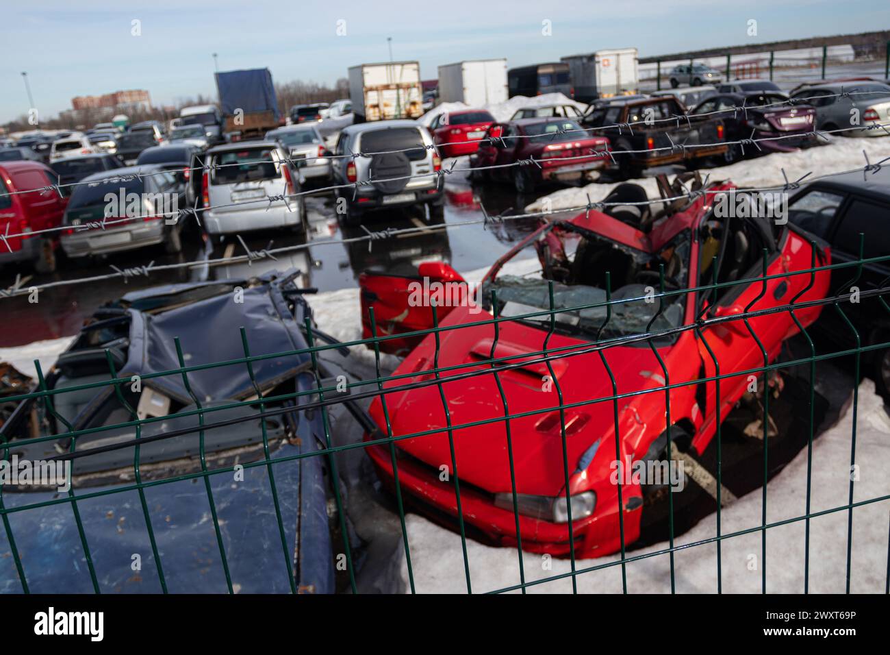 Broken and burnt cars after road accidents stand in a special parking ...