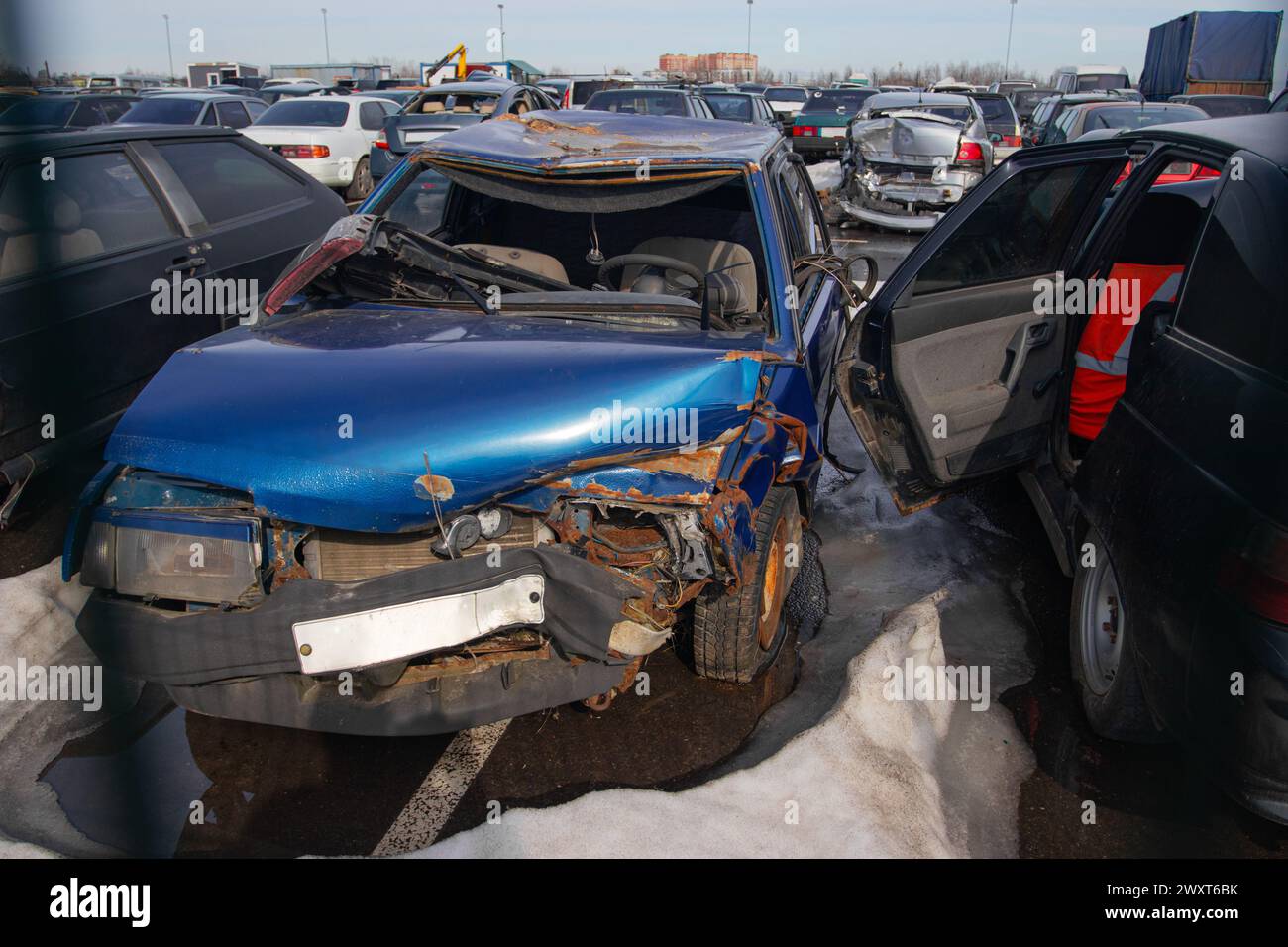 Broken and burnt cars after road accidents stand in a special parking ...