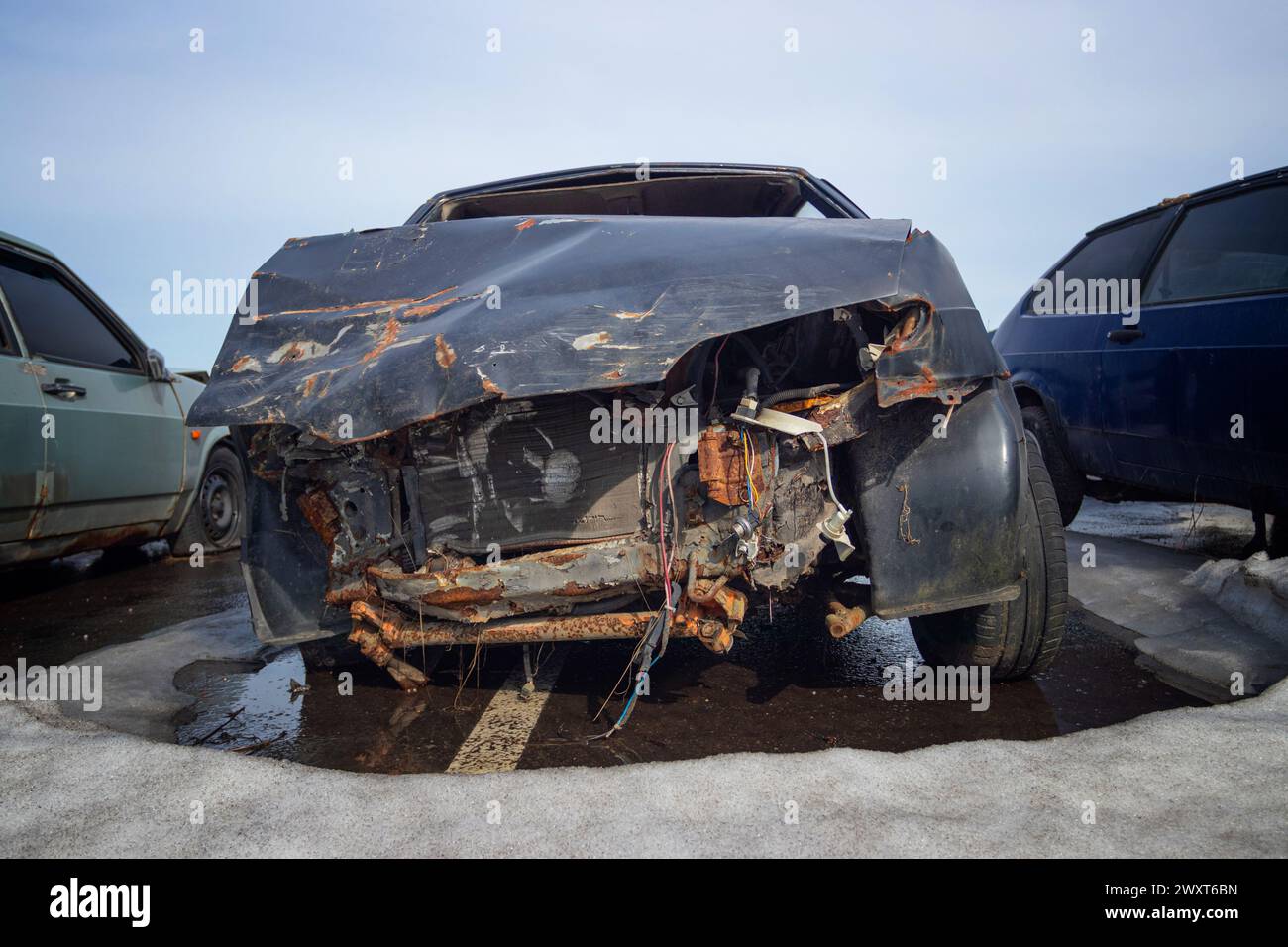 Broken and burnt cars after road accidents stand in a special parking ...
