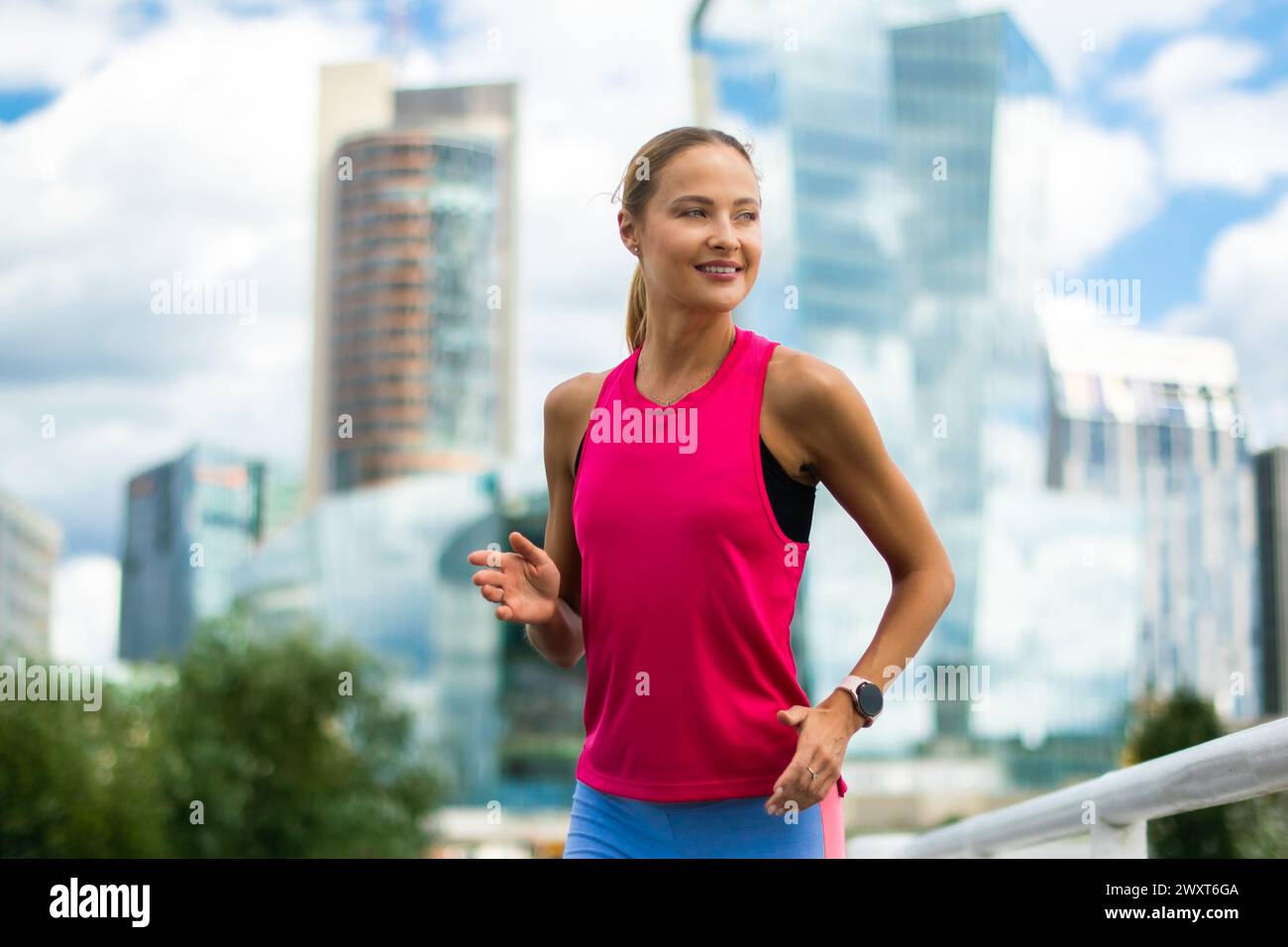 Beautiful woman running in an urban setting Stock Photo - Alamy