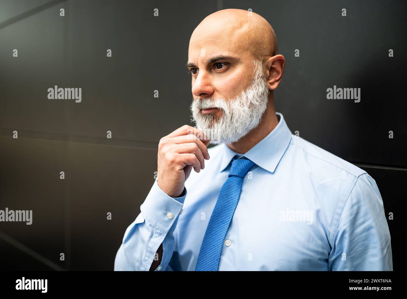 Mature bald stylish business man portrait outdoor in a pensive ...