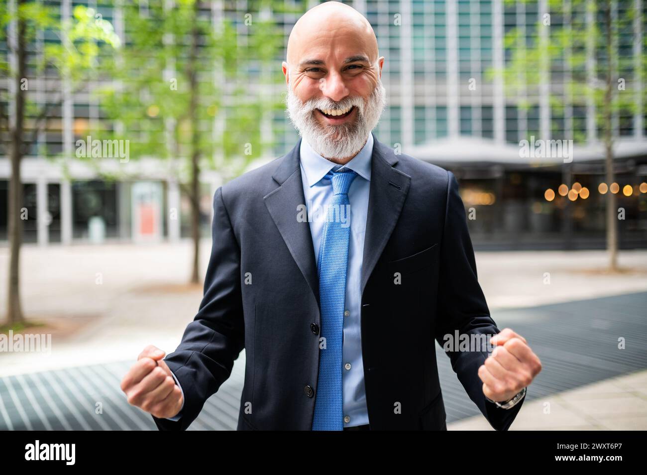 Businessman in victory pose hi-res stock photography and images - Alamy