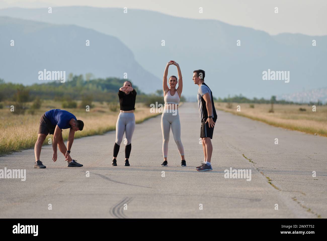 Diverse Group of Athletes Prepare Together for a Run Stock Photo - Alamy
