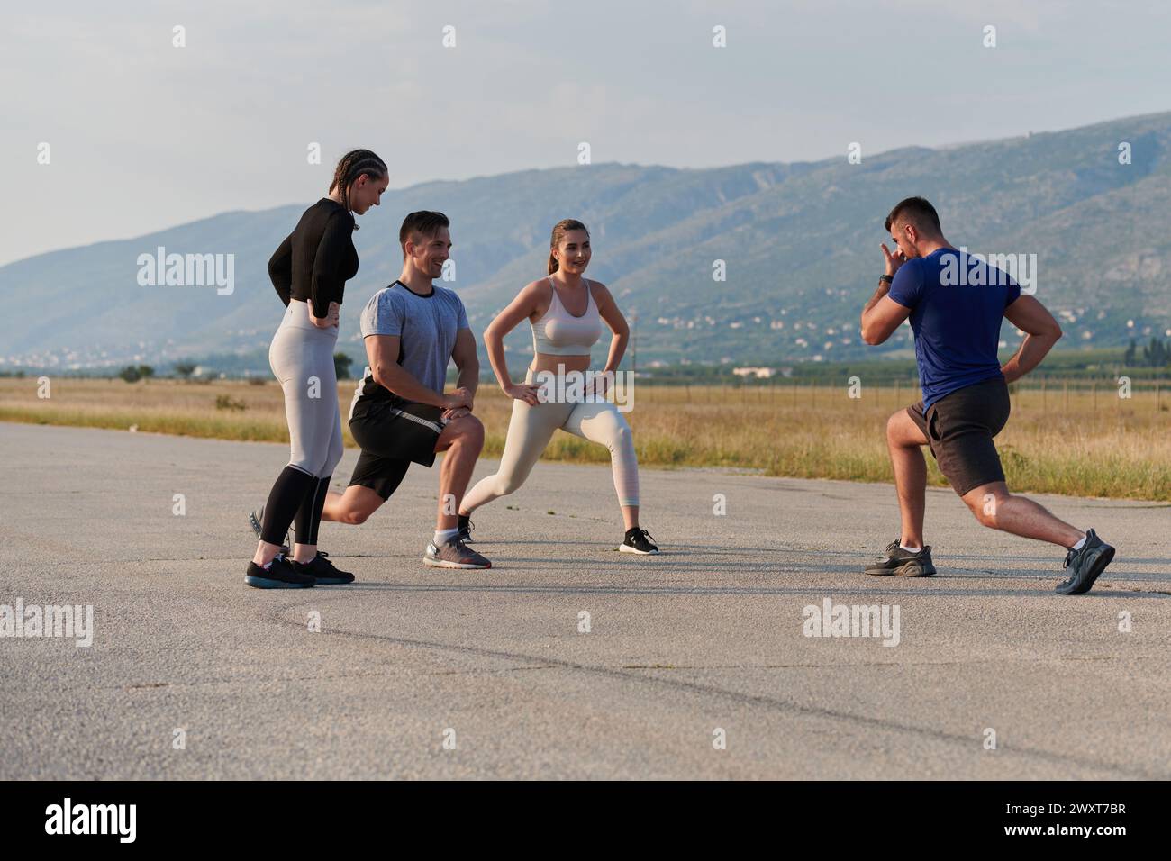 Diverse Group of Athletes Prepare Together for a Run Stock Photo - Alamy