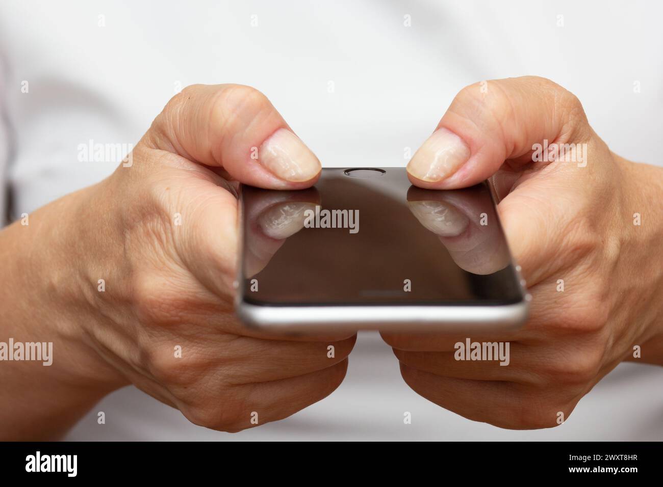 Woman hands holding smartphone concept Arthritis Stock Photo - Alamy