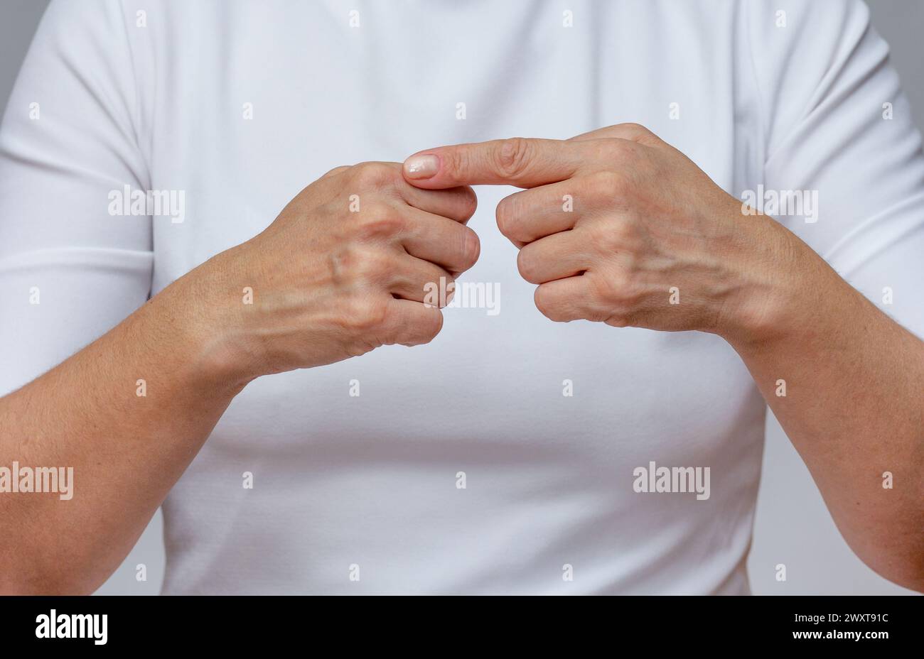 Woman index finger pointing at the first digital knuckle on hand to ...