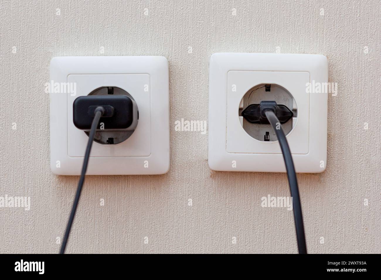 Two sockets with plugs inside Stock Photo - Alamy