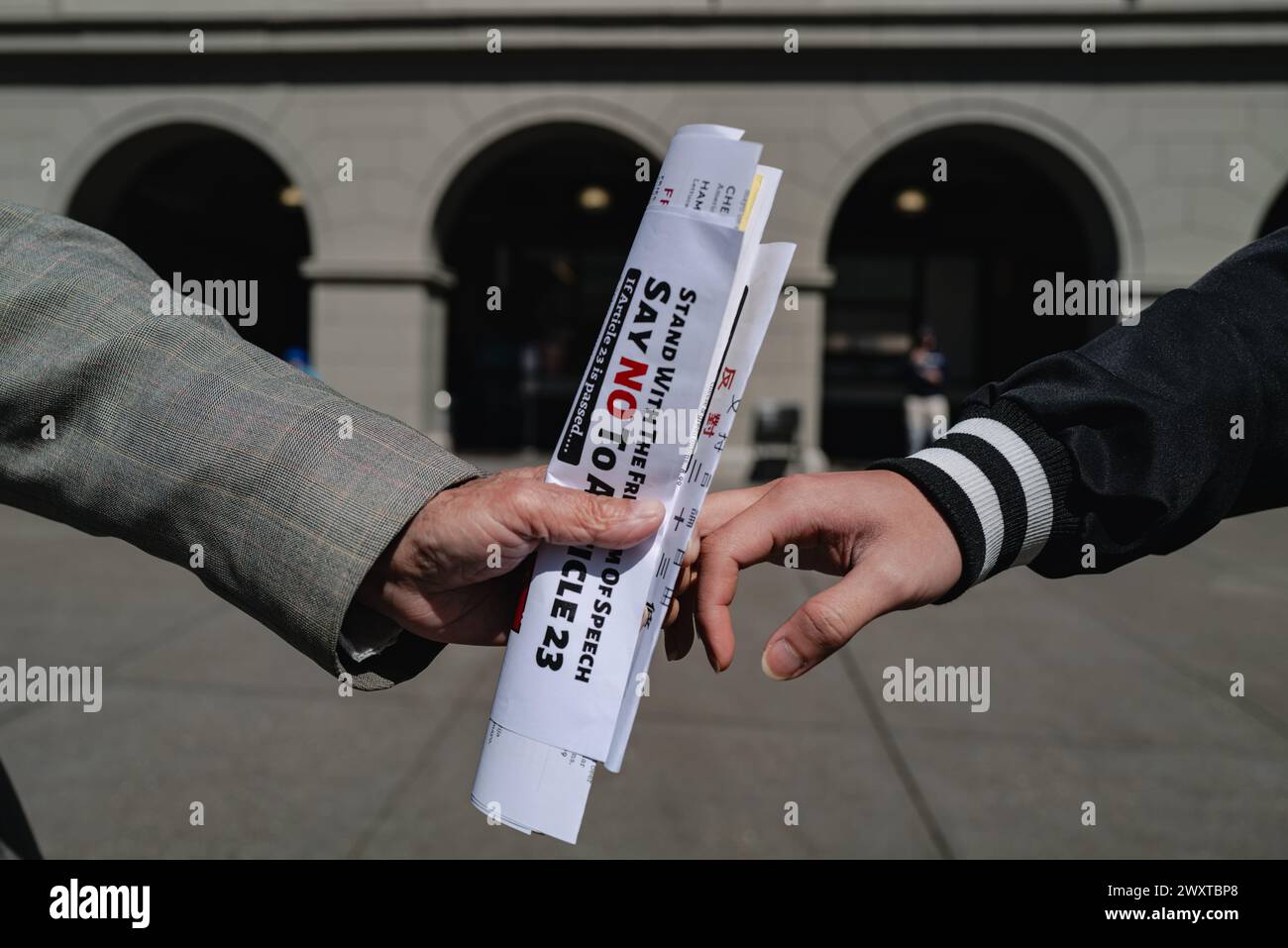 Protesters link arms in solidarity, forming a human chain that ...