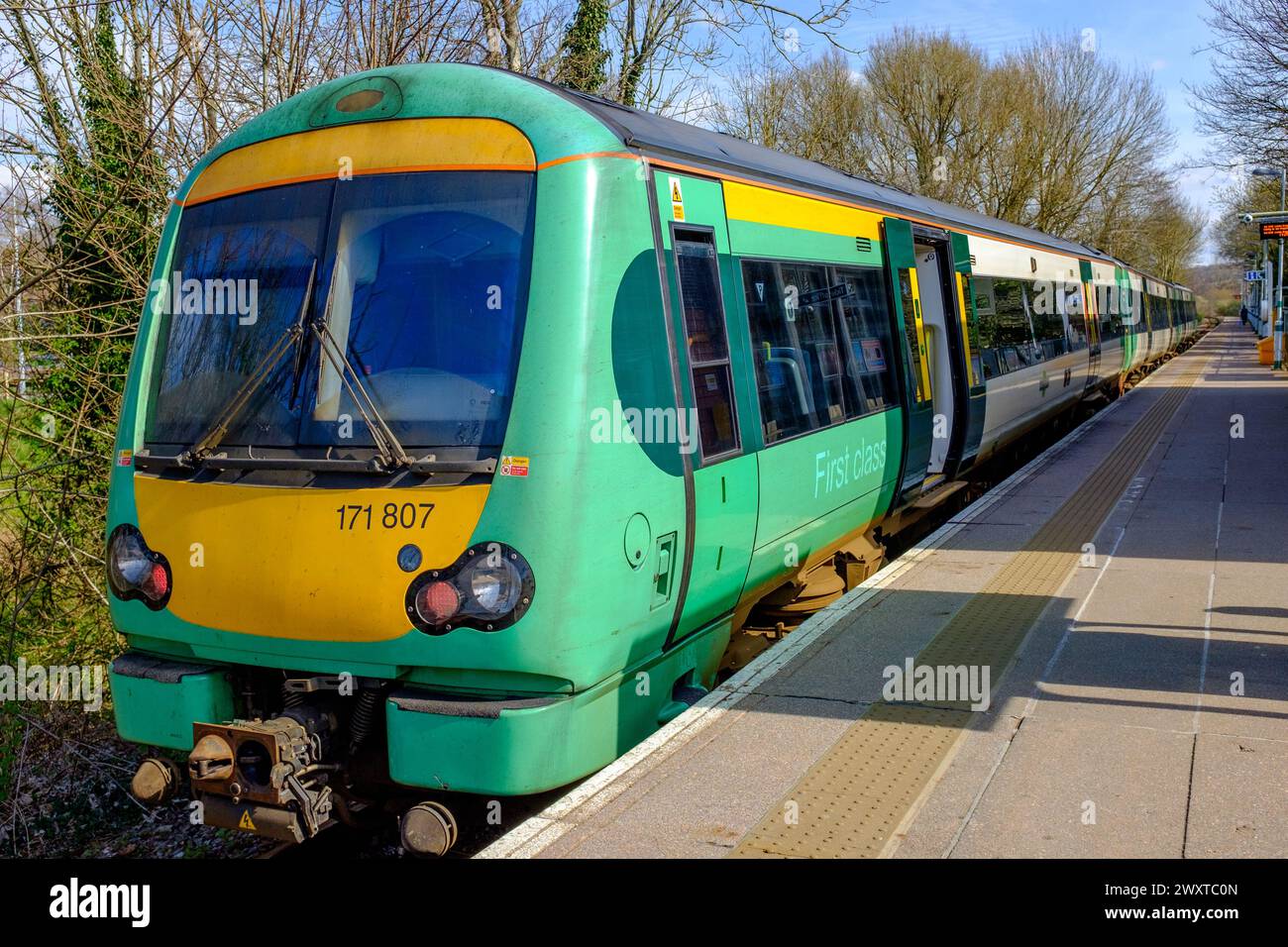 A Southern Railway train in green and yellow livery stands with its ...