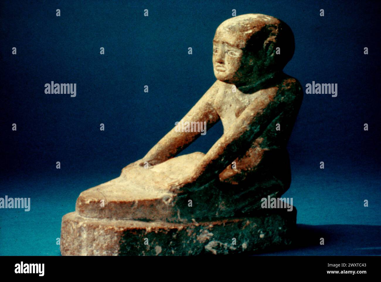 Man grinding grain with a saddle-quern, Egyptian statue, Egypt 2500 BC ...