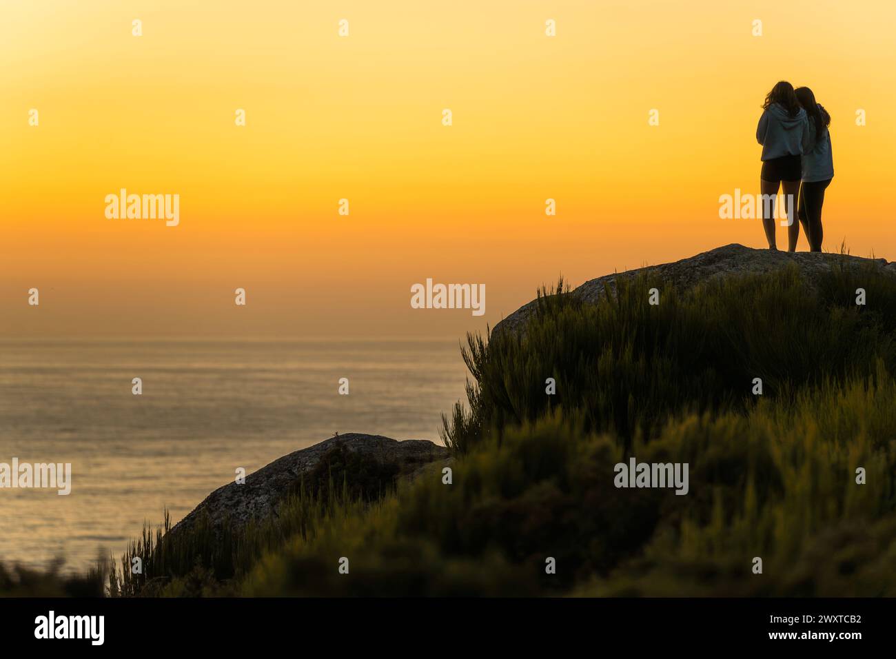 Silhouette two women watching sunset hi-res stock photography and ...