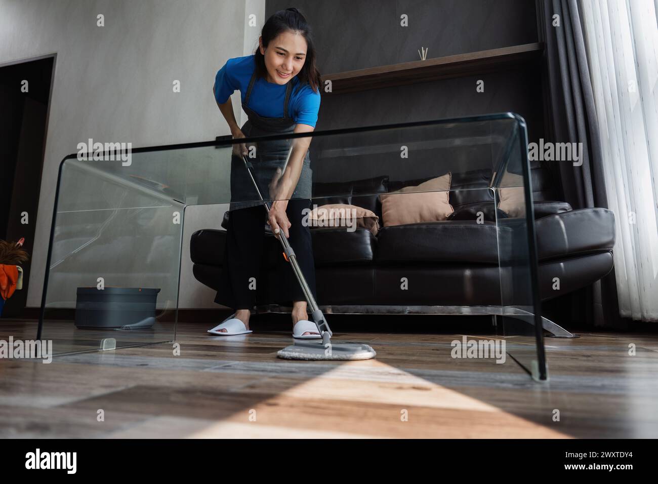 cleaning service housekeeper women swipe floor in living room. House ...