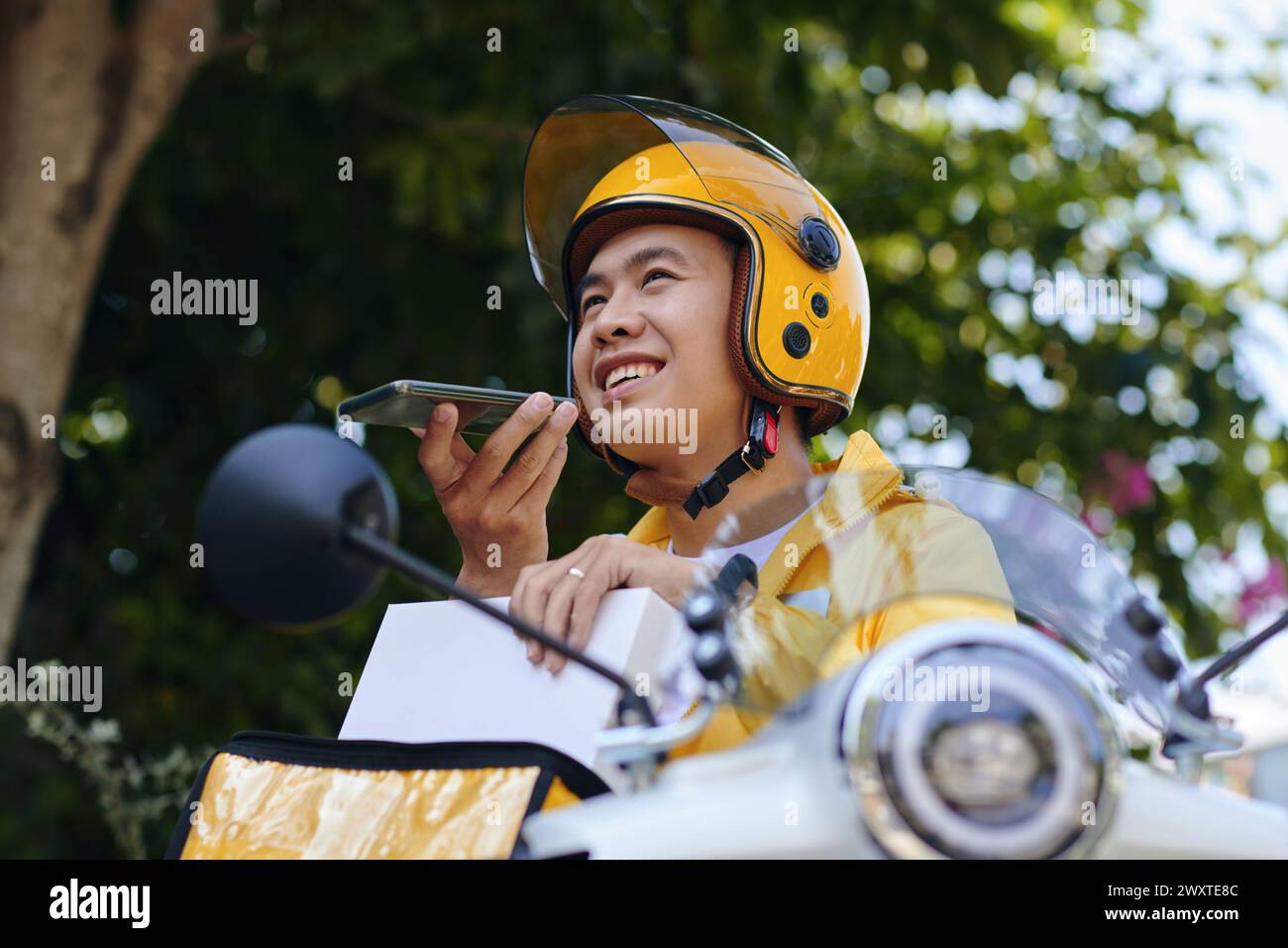 Smiling vietnamese man recording voice hi-res stock photography and ...