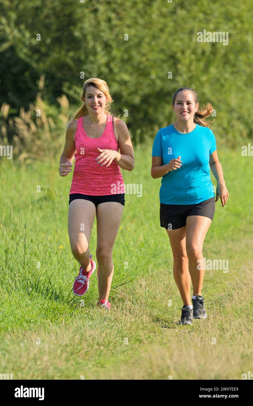 Two young people running outdoor hi-res stock photography and images ...