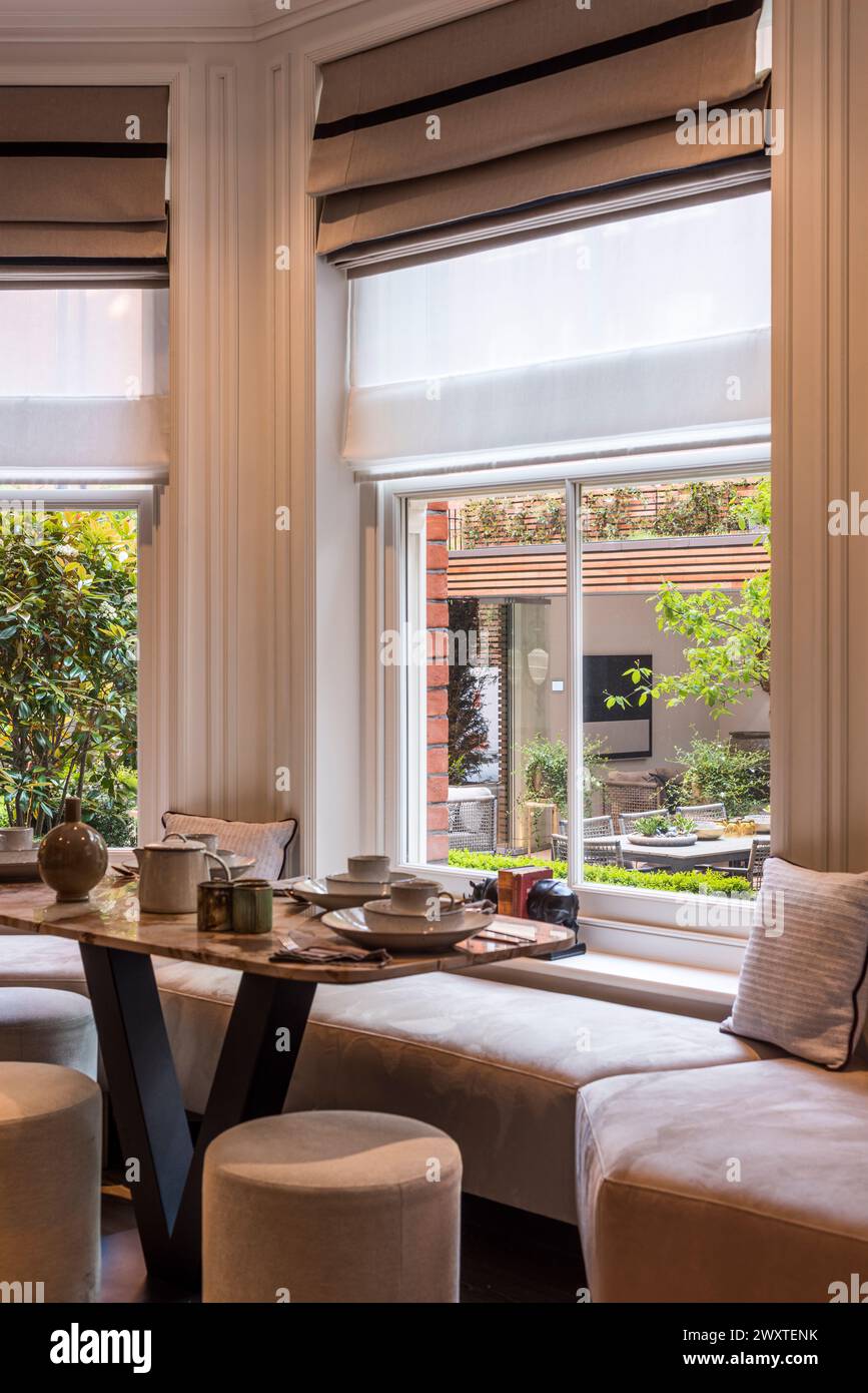 Window seating and table with privacy blinds in Chelsea townhouse, West ...