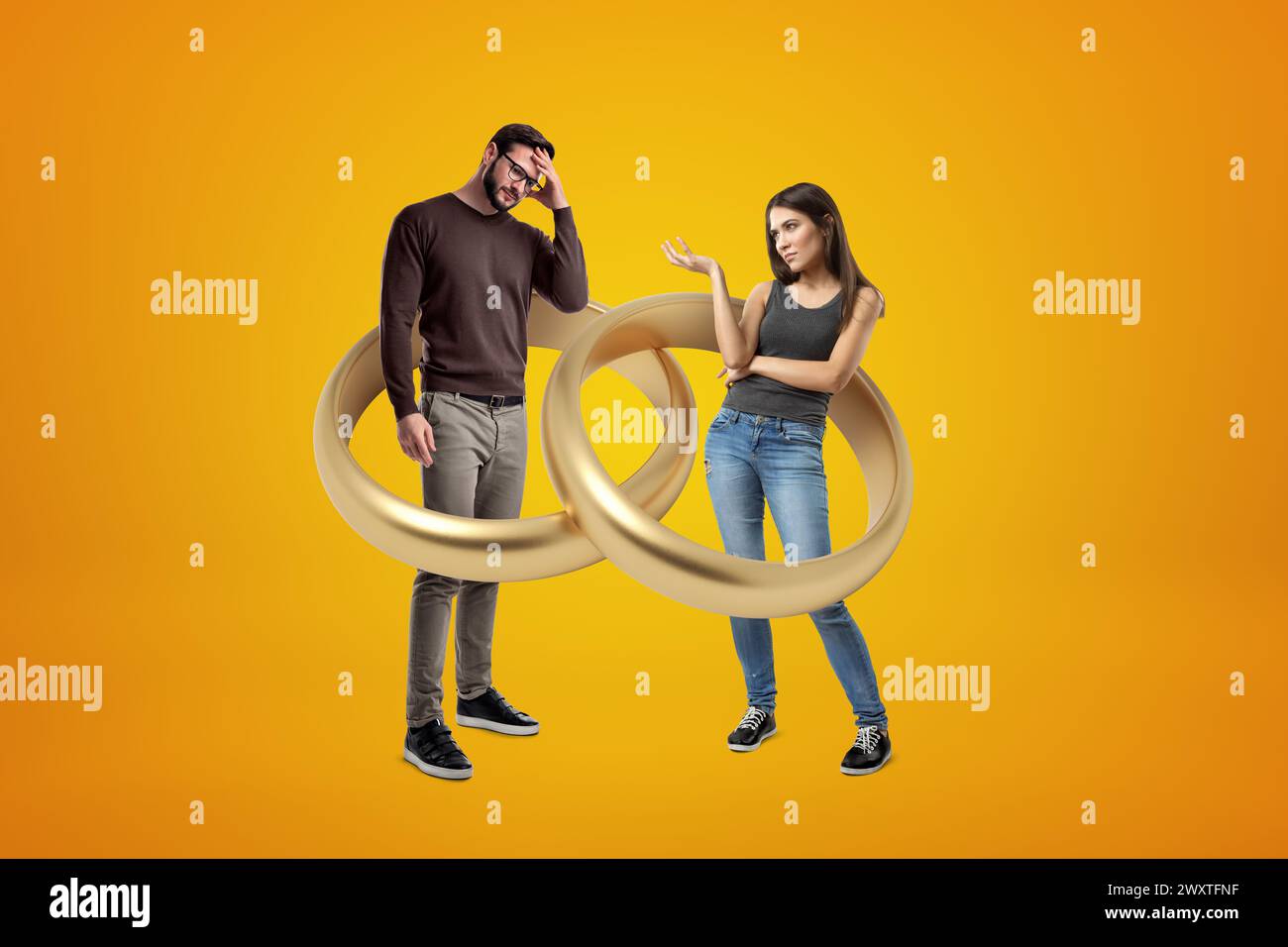 Couple in an entangled gold ring illusion Stock Photo - Alamy