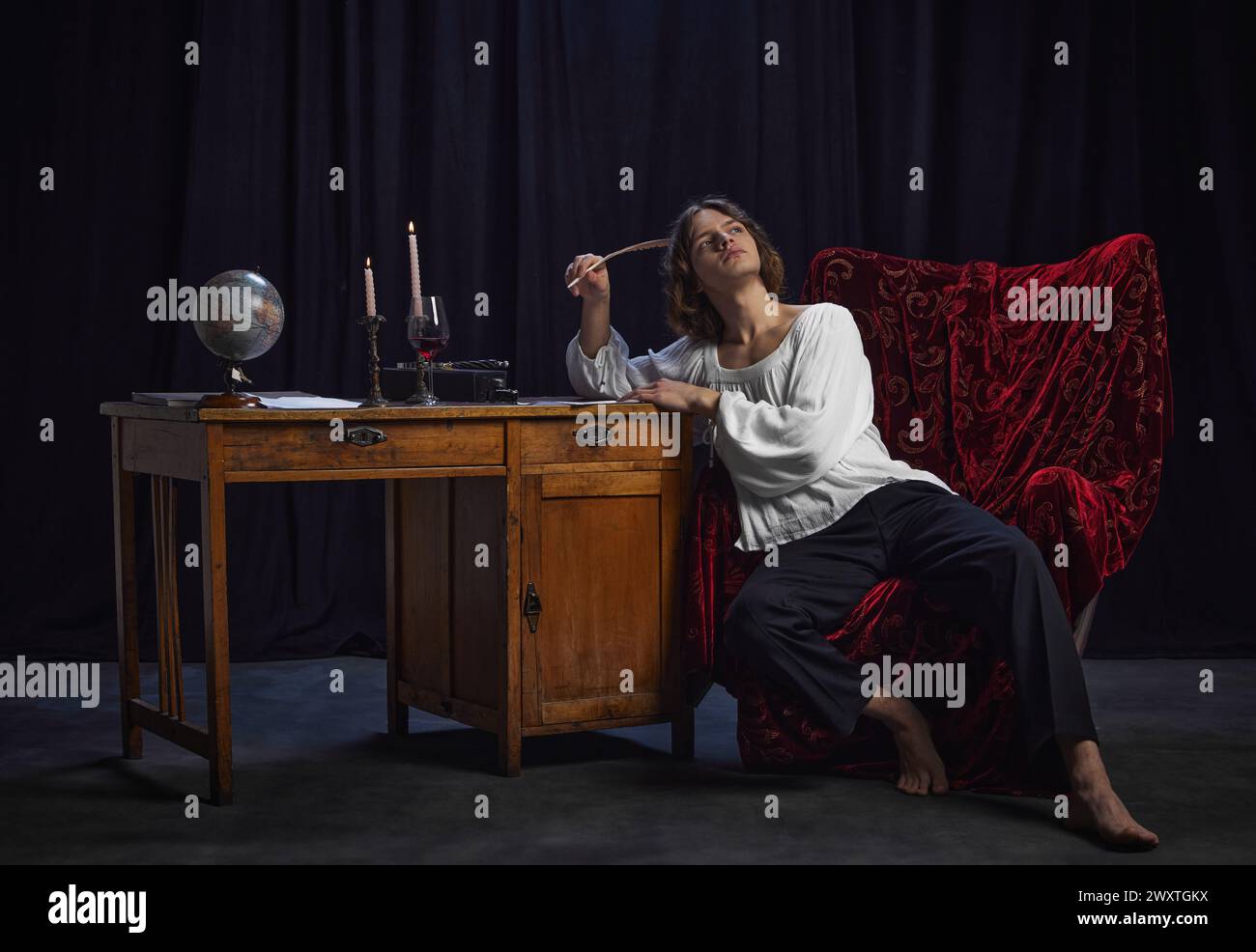 Thoughtful man, poet in old-fashion costume sitting in vintage chair ...