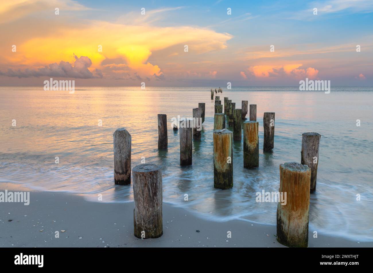 Wooden posts shore sky sunset beach hi-res stock photography and images ...