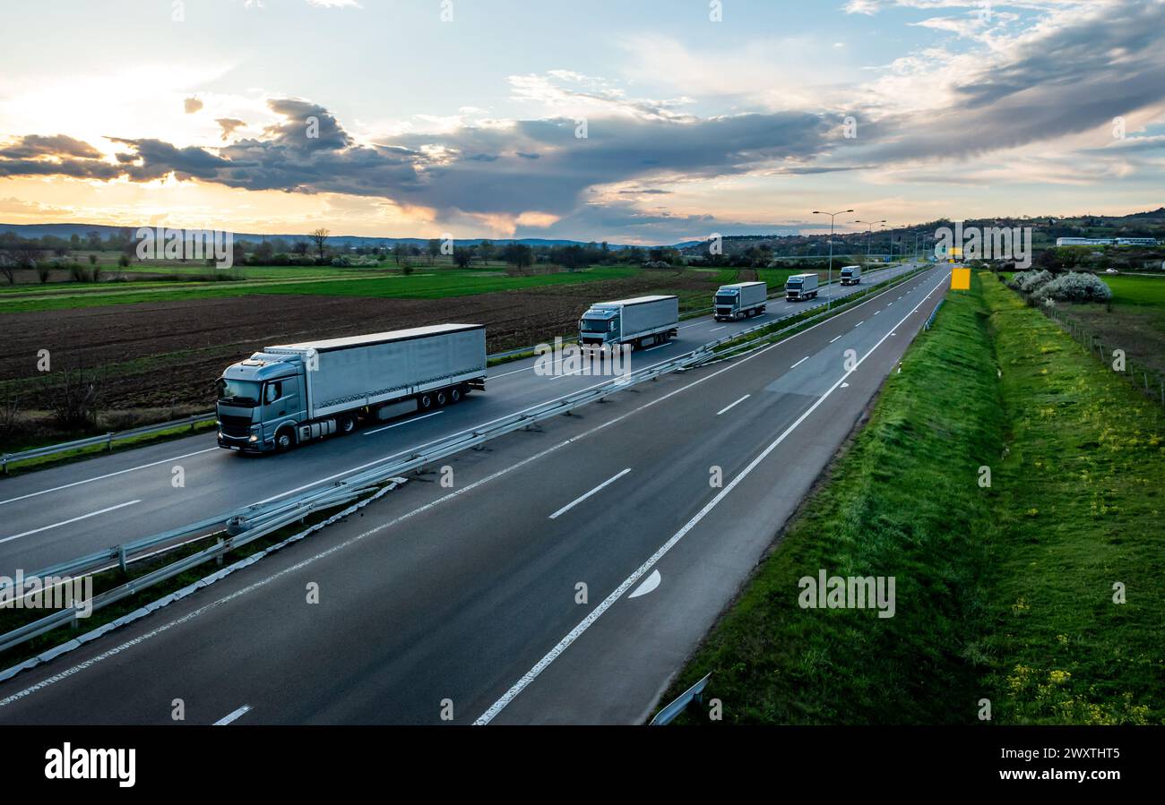 Convoy of Trucks with containers on highway, cargo transportation ...
