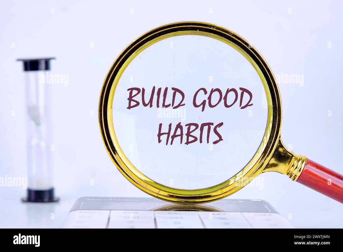 BUILD GOOD HABITS motivational concept text through a magnifying glass ...