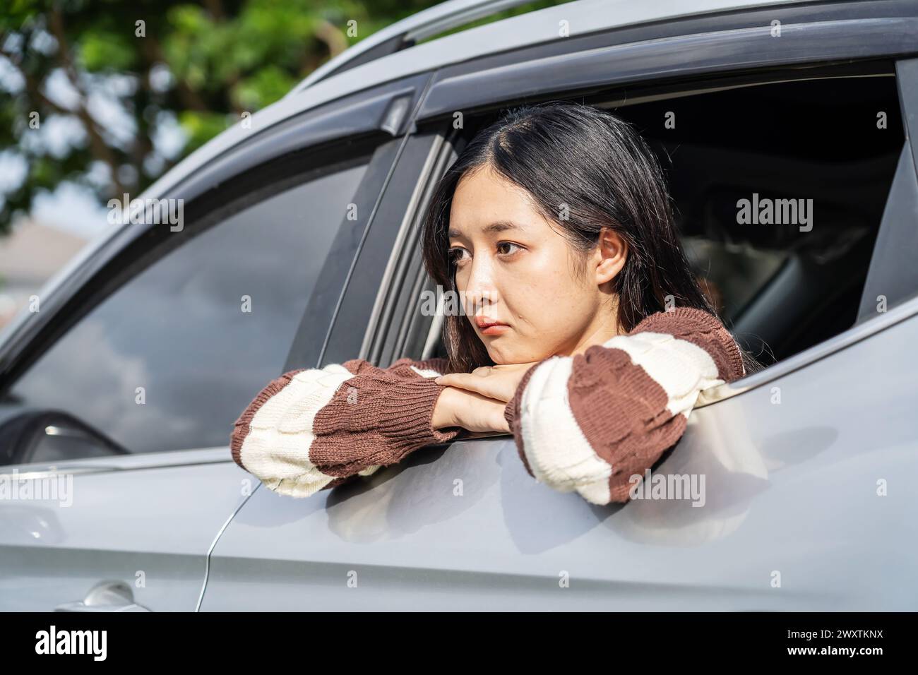 A woman sadly gazing out of a car window Stock Photo - Alamy