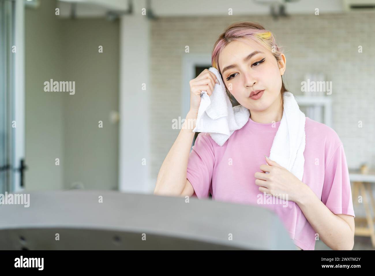 An asian beautiful woman cleaning her sweat while running on the ...