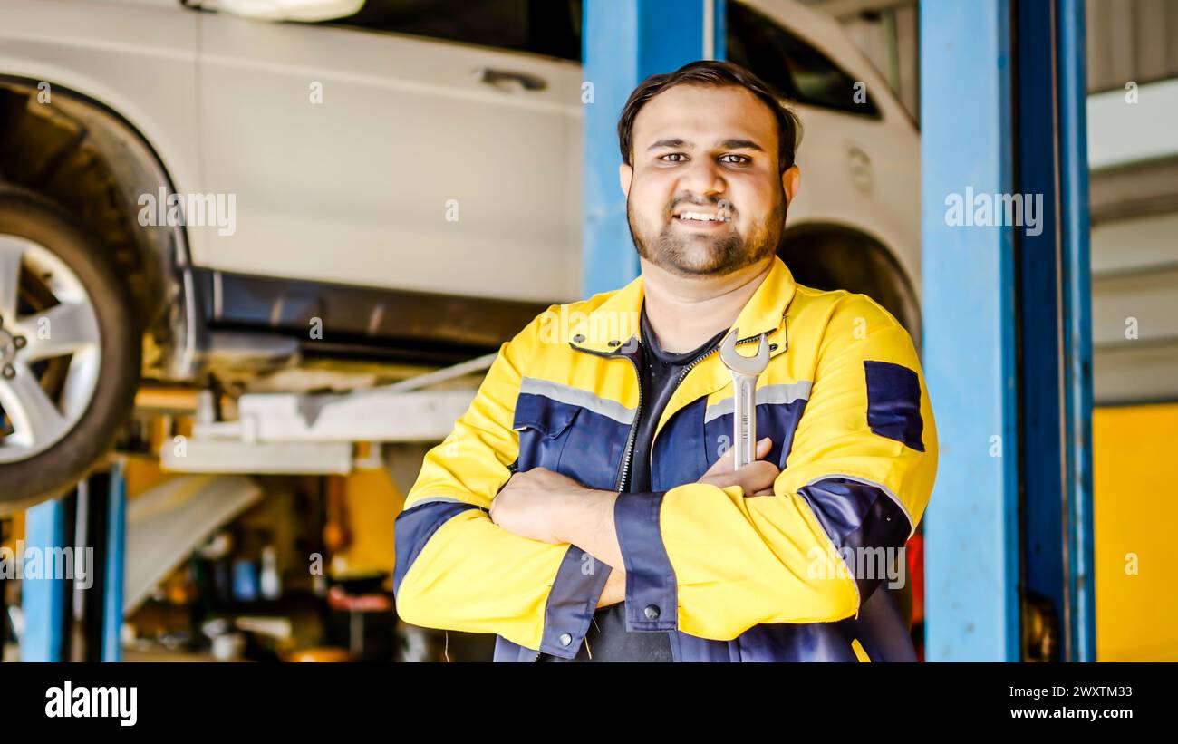 A man posing with arms folded, confident stance Stock Photo - Alamy