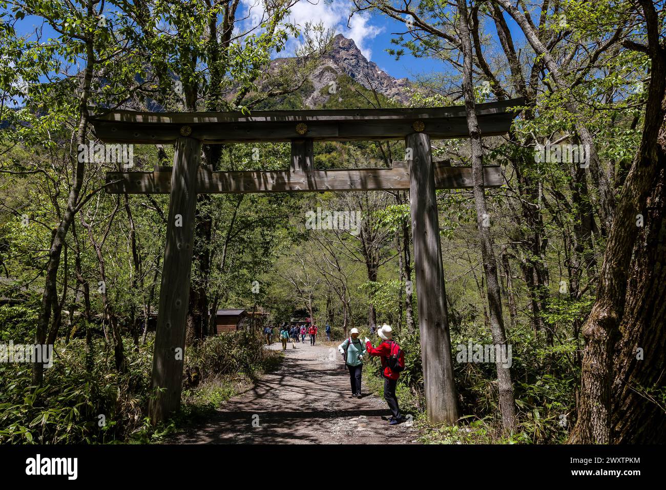 KAMIKOCHI, JAPAN - MAY 24 2023: Hikers passing under the Torii gate of ...