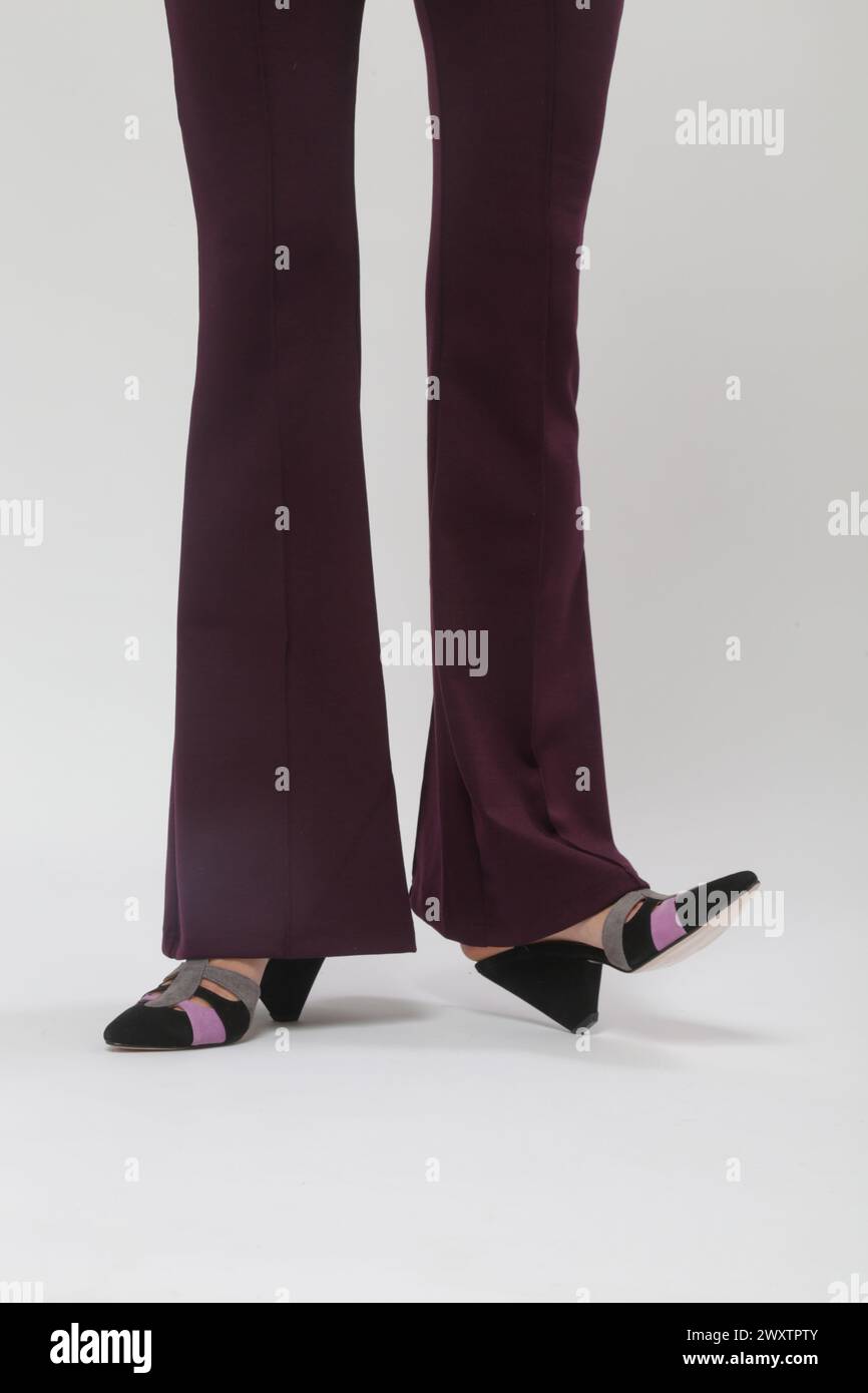 Serie of studio photos of young female model wearing basic flared ...