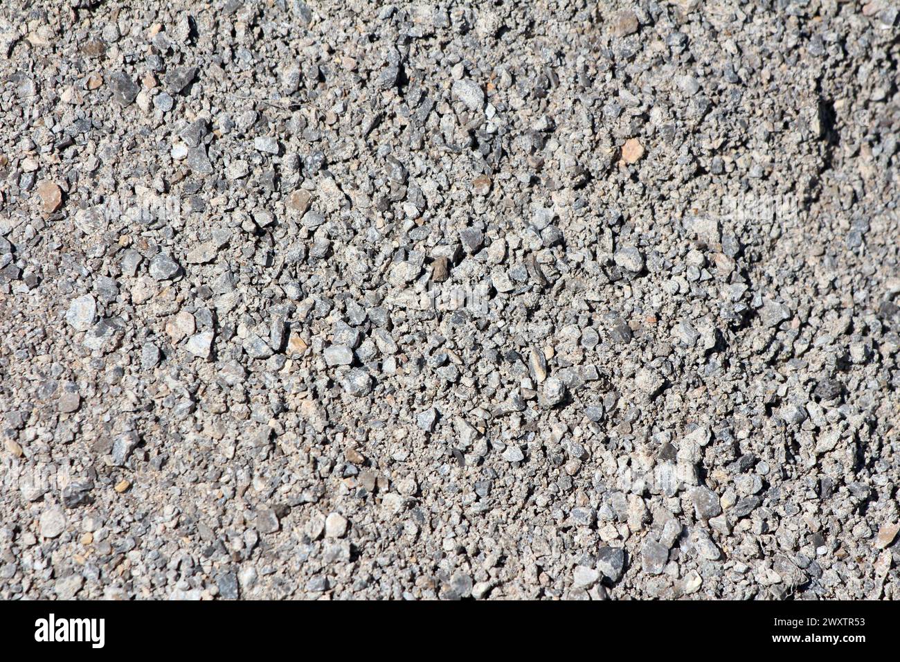 Wet washed out white and grey various size gravel at local construction ...