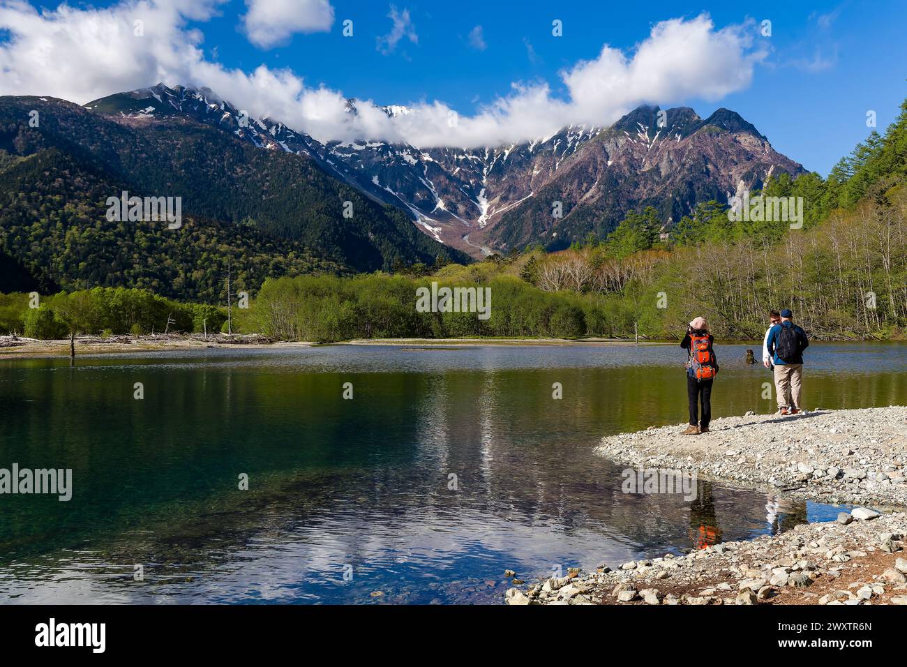 KAMIKOCHI, JAPAN - MAY 24 2023: Hikers next to a pond and the Azusa ...