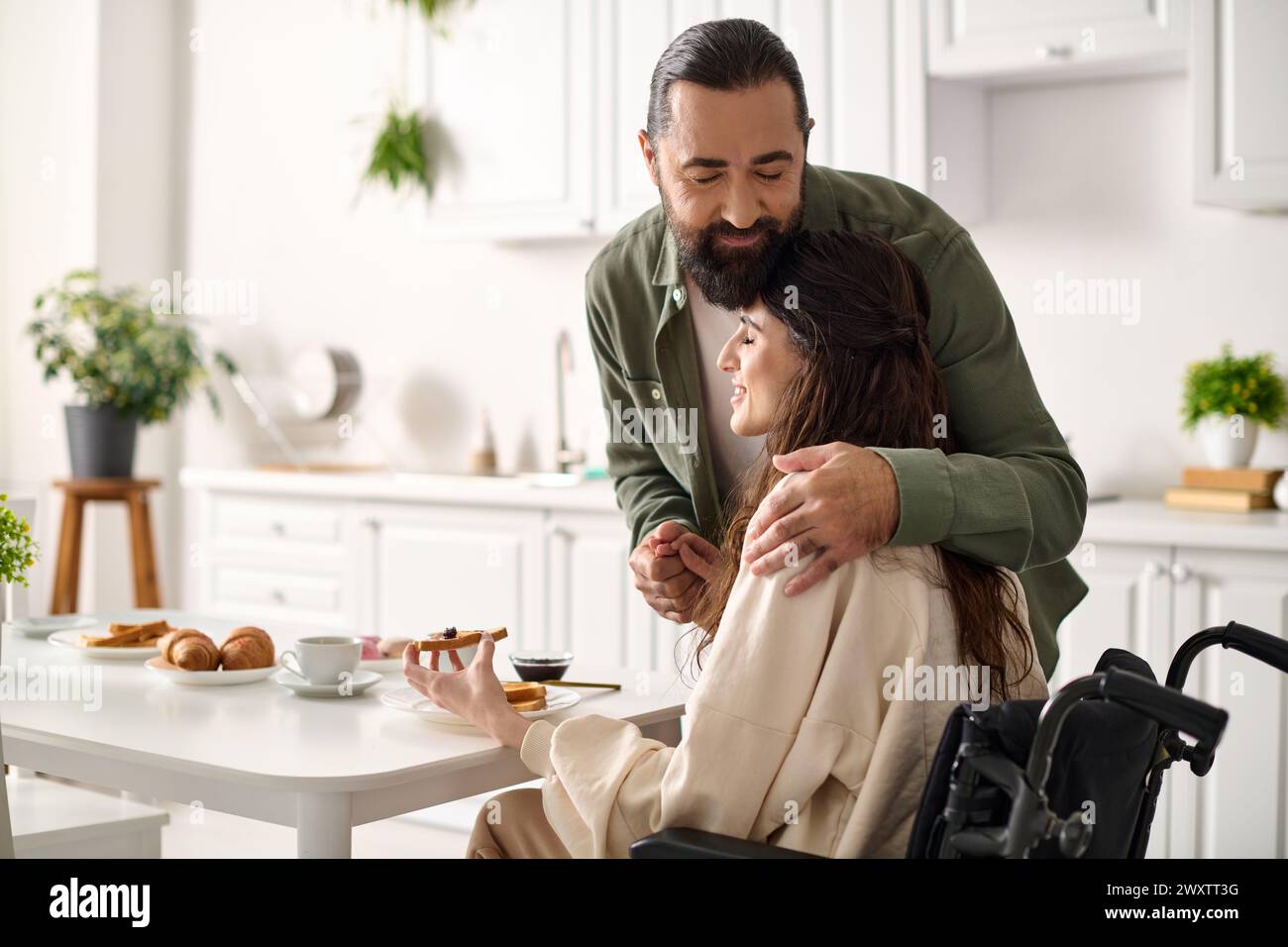 joyful attractive woman with disability in wheelchair eating breakfast ...