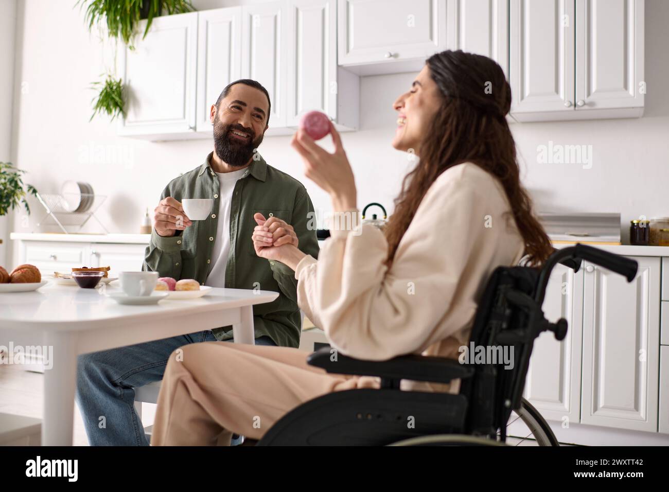 joyful woman with inclusivity in wheelchair eating sweets at breakfast ...