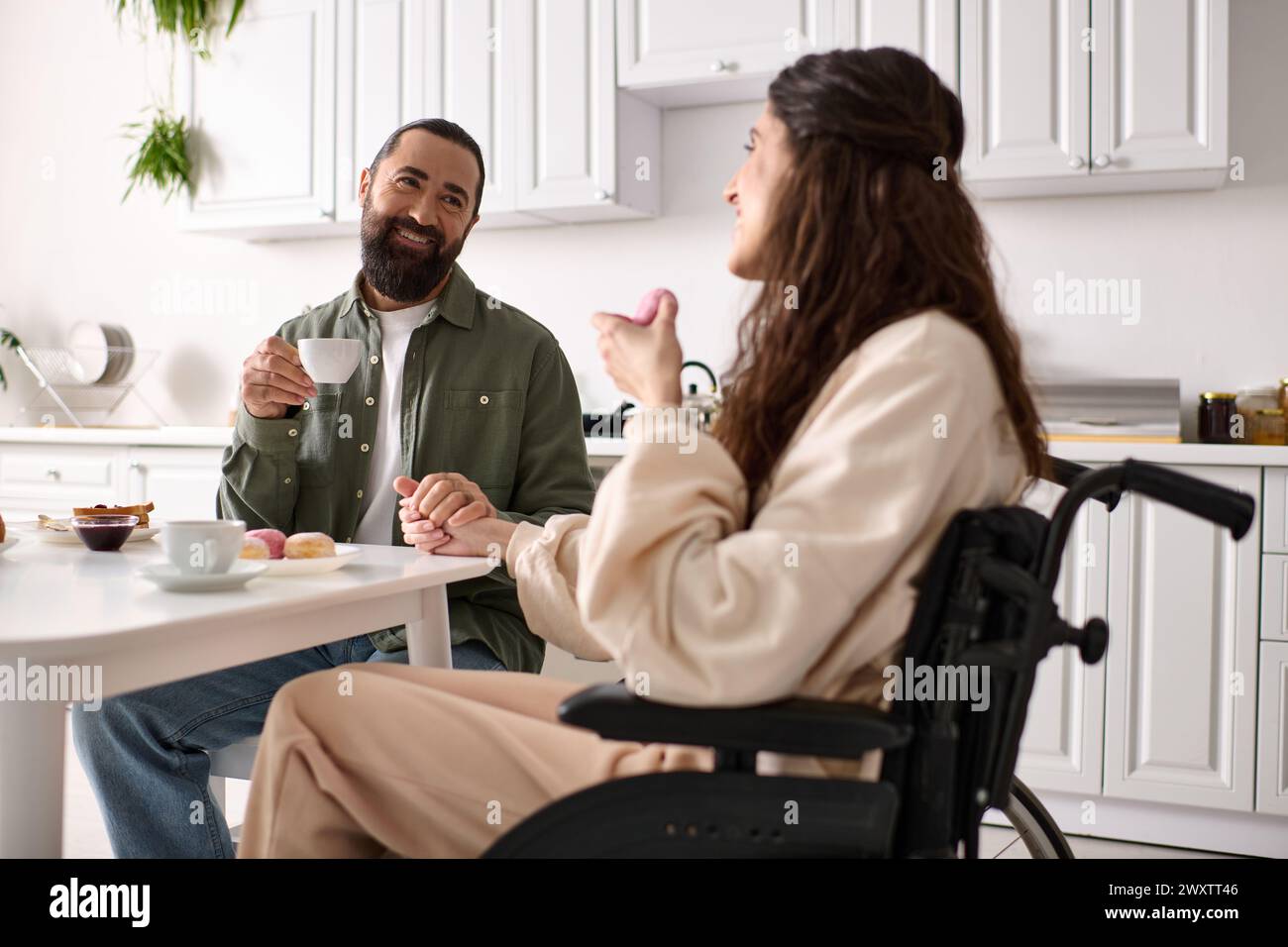 joyful woman with inclusivity in wheelchair eating sweets at breakfast ...
