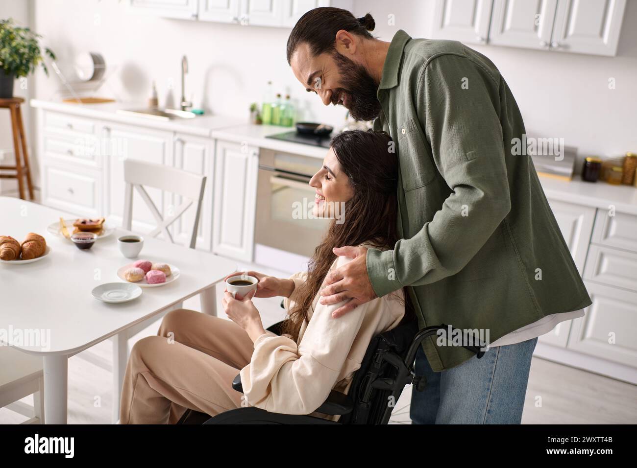 positive loving man spending time at breakfast with his disabled ...