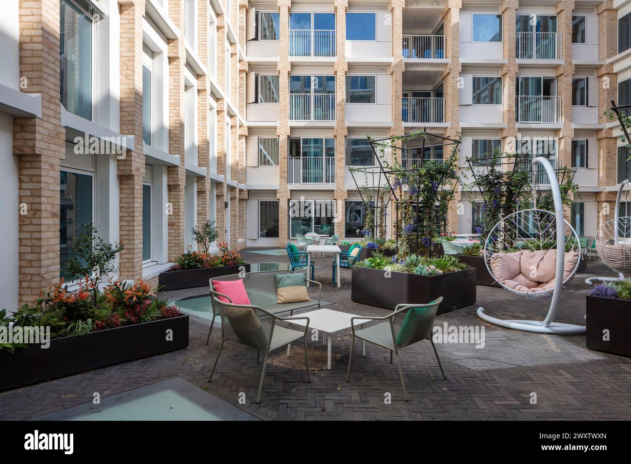 Internal communal garden space. Wick Park, London, United Kingdom. Architect: Ayre Chamberlain ...