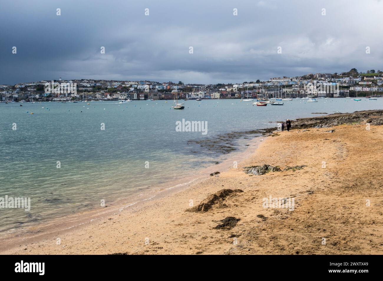The quiet little sandy beach at Flushing, Cornwall, with a view across ...