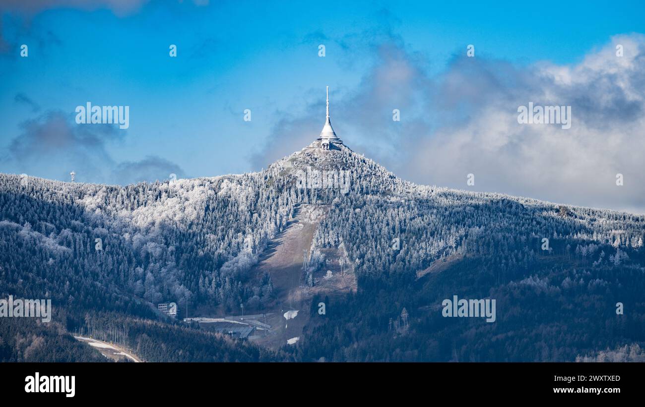 A crisp morning view of the snow-covered Jested peak with its iconic ...