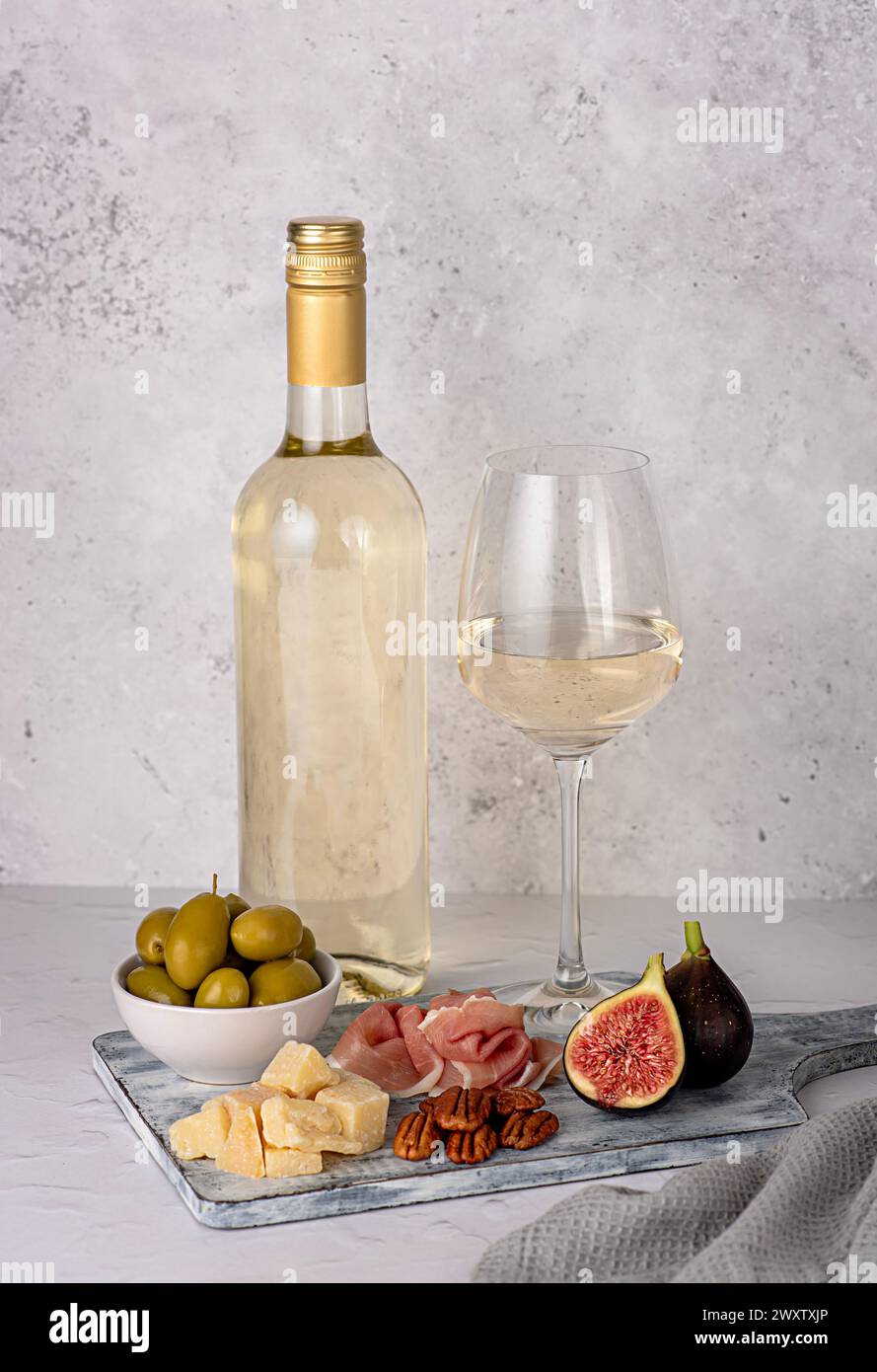 Food photography of white wine; cheese; parmesan; fig; prosciutto ...