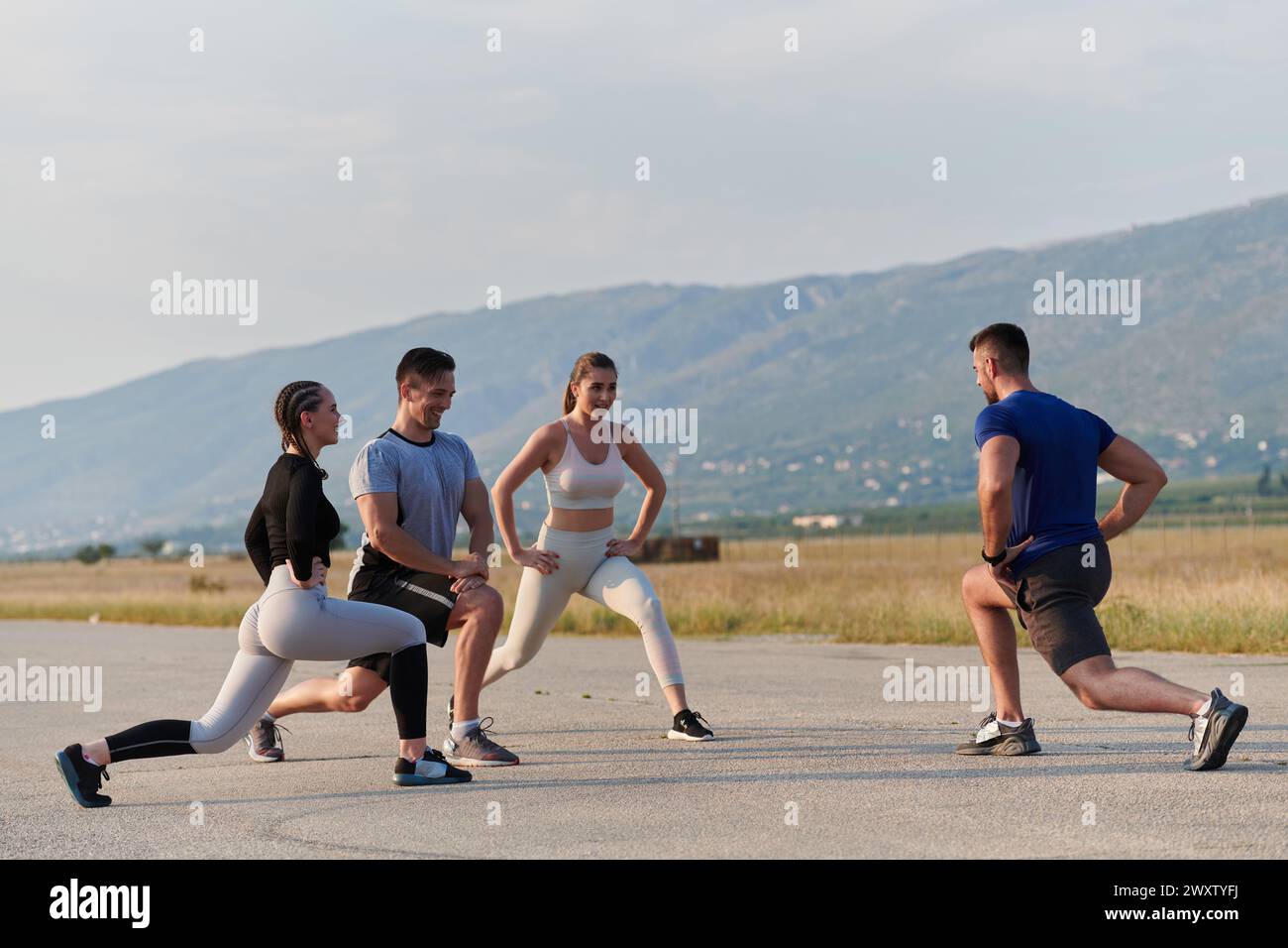 Diverse Group of Athletes Prepare Together for a Run Stock Photo - Alamy