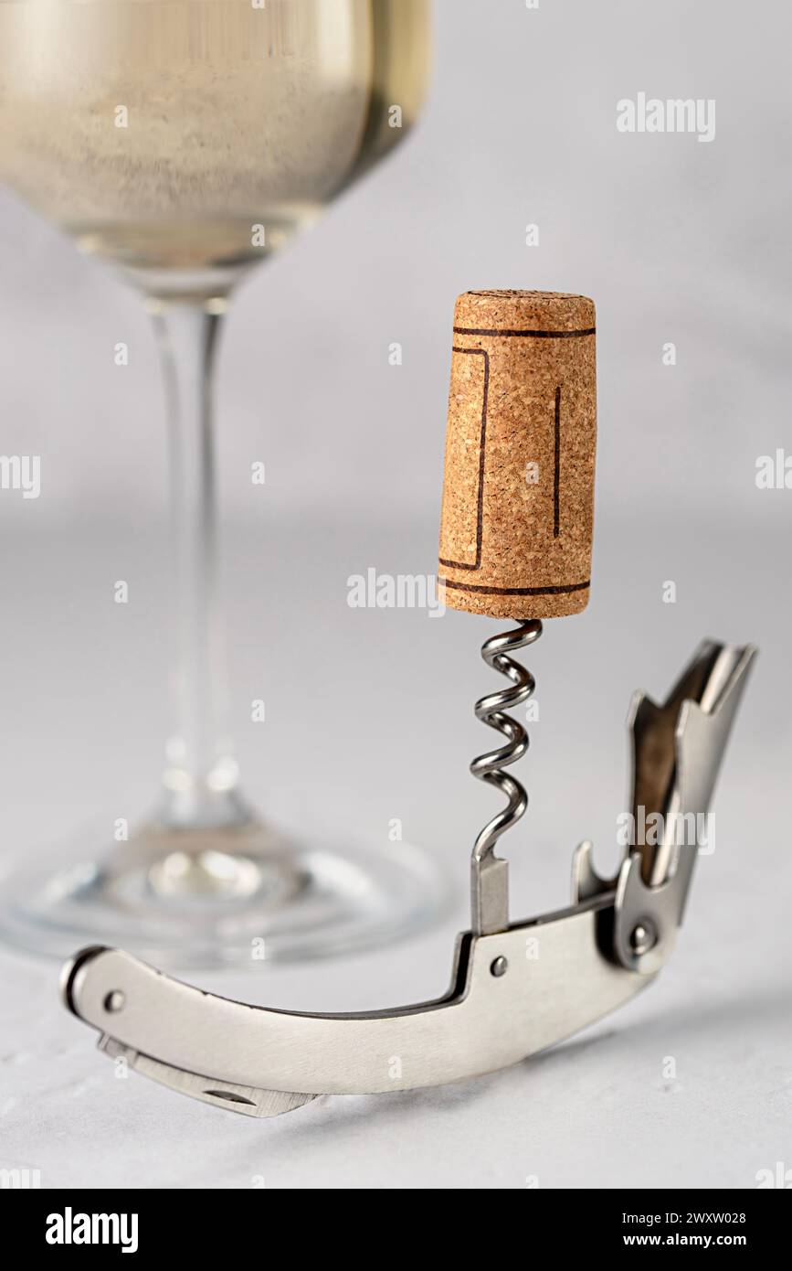 Macro photography of white wine; wineglass; cork; corkscrew; winery ...
