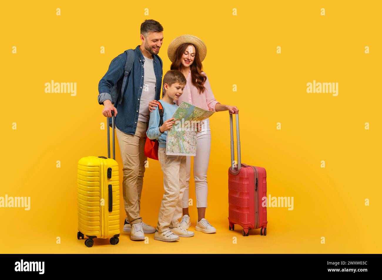 Family ready for vacation with suitcases and map Stock Photo - Alamy