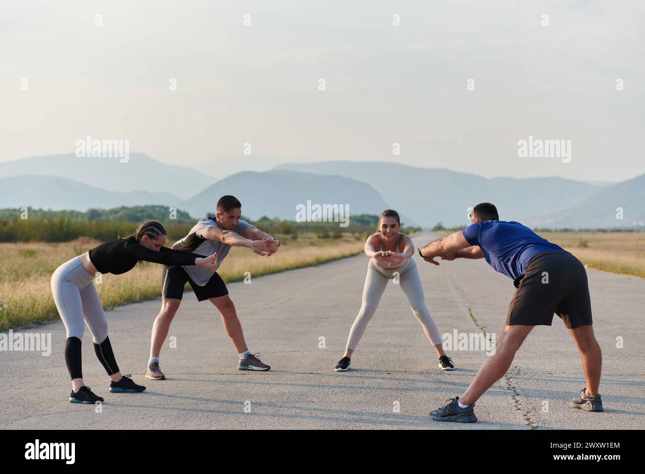 Diverse Group of Athletes Prepare Together for a Run Stock Photo - Alamy